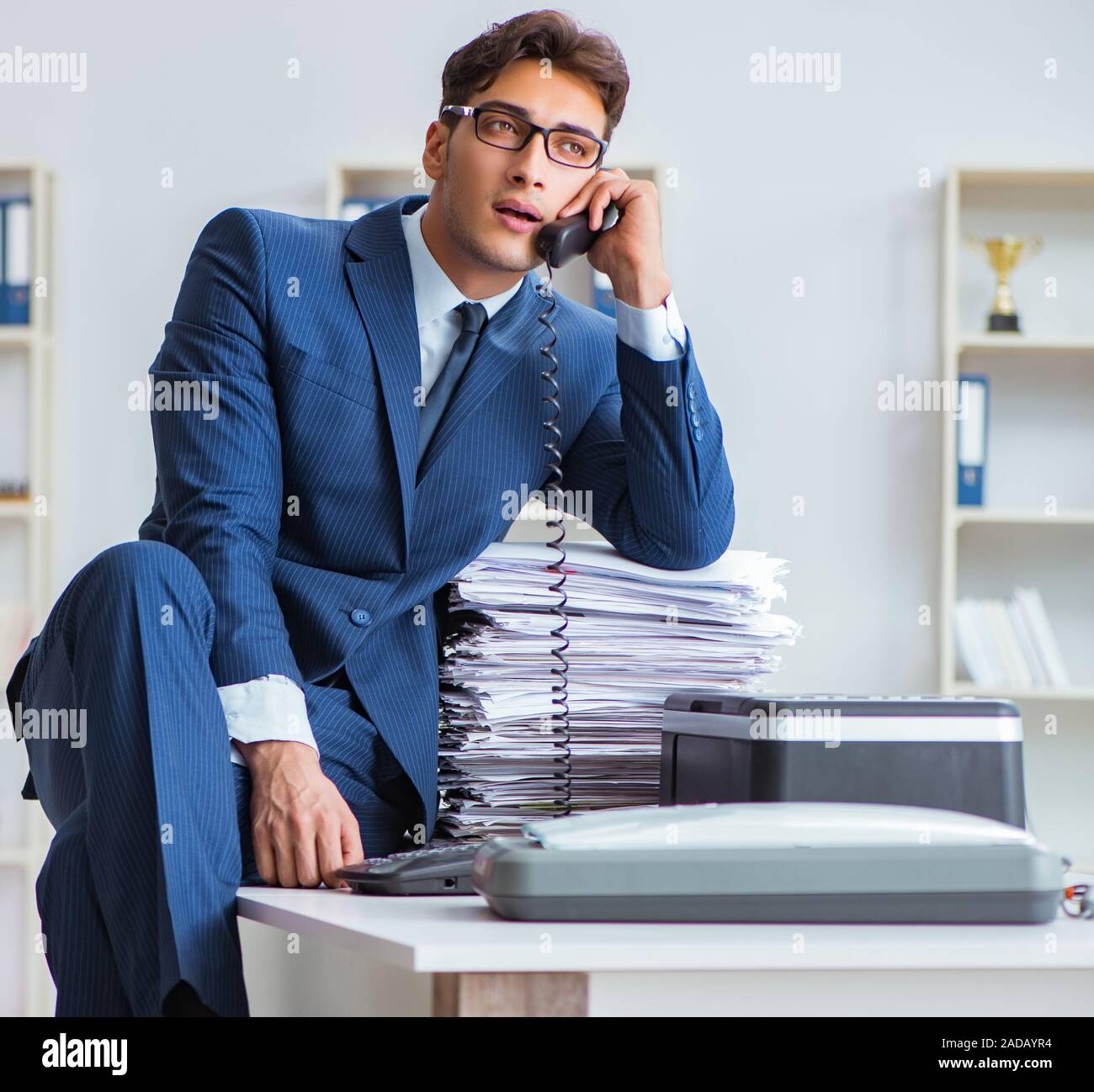 Businessman making copies in copying machine Stock Photo - Alamy