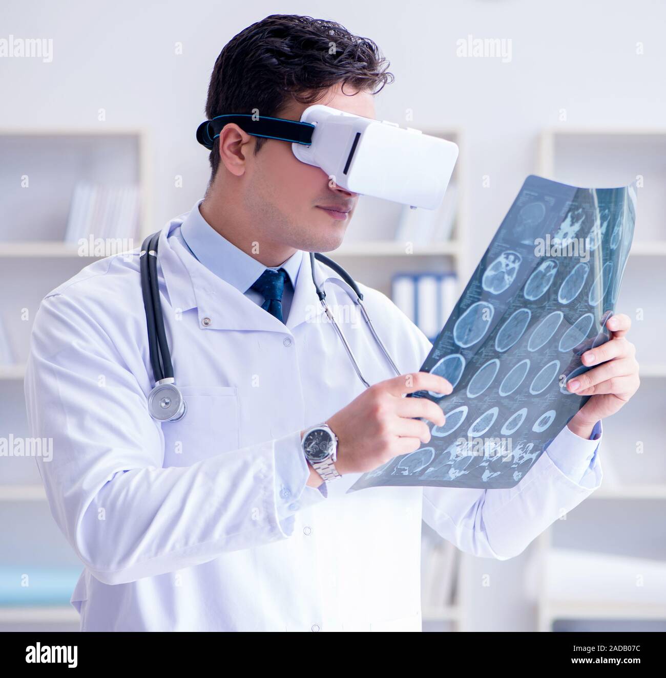 Young doctor looking at MRI scan through VR glasses Stock Photo - Alamy