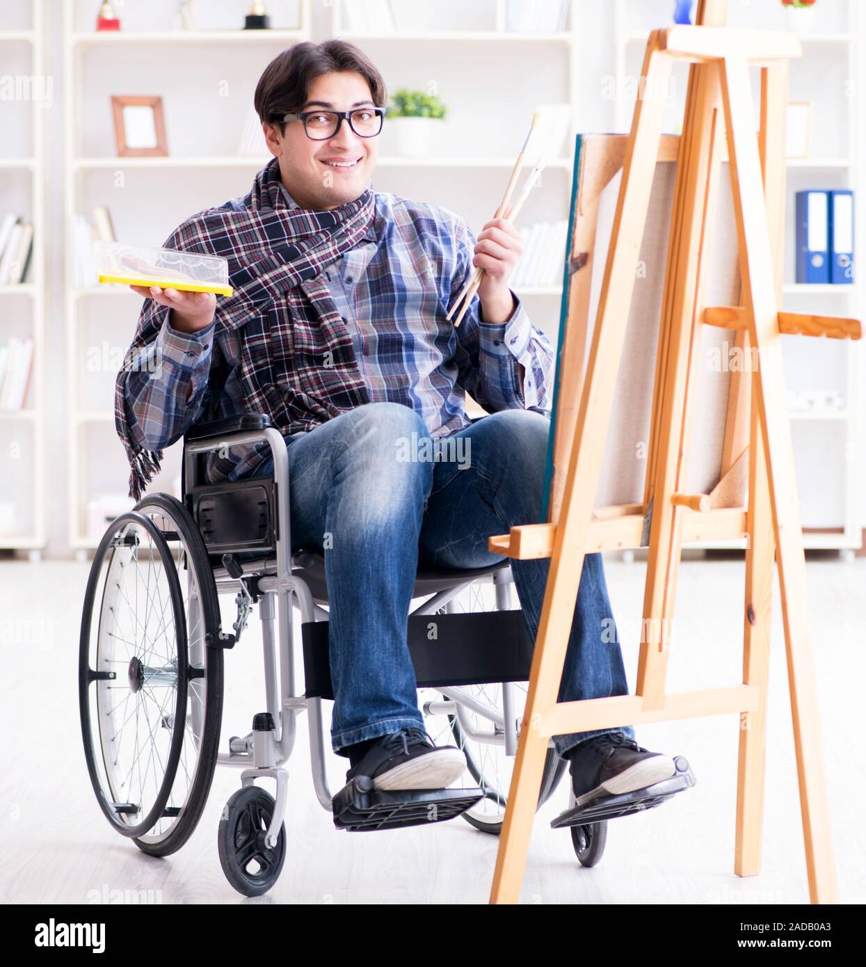 Disabled artist painting picture in studio Stock Photo - Alamy