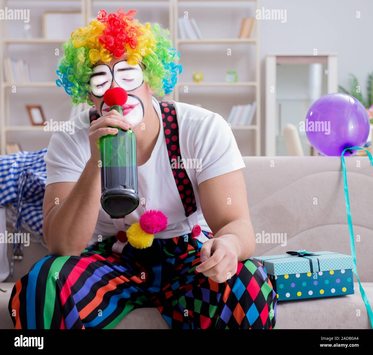 Drunk clown celebrating having a party at home Stock Photo - Alamy