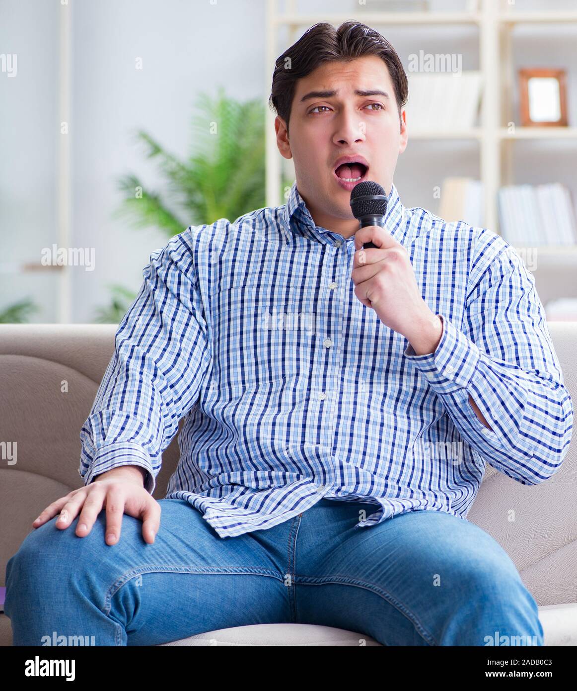 Funny man singing songs in karaoke at home Stock Photo - Alamy