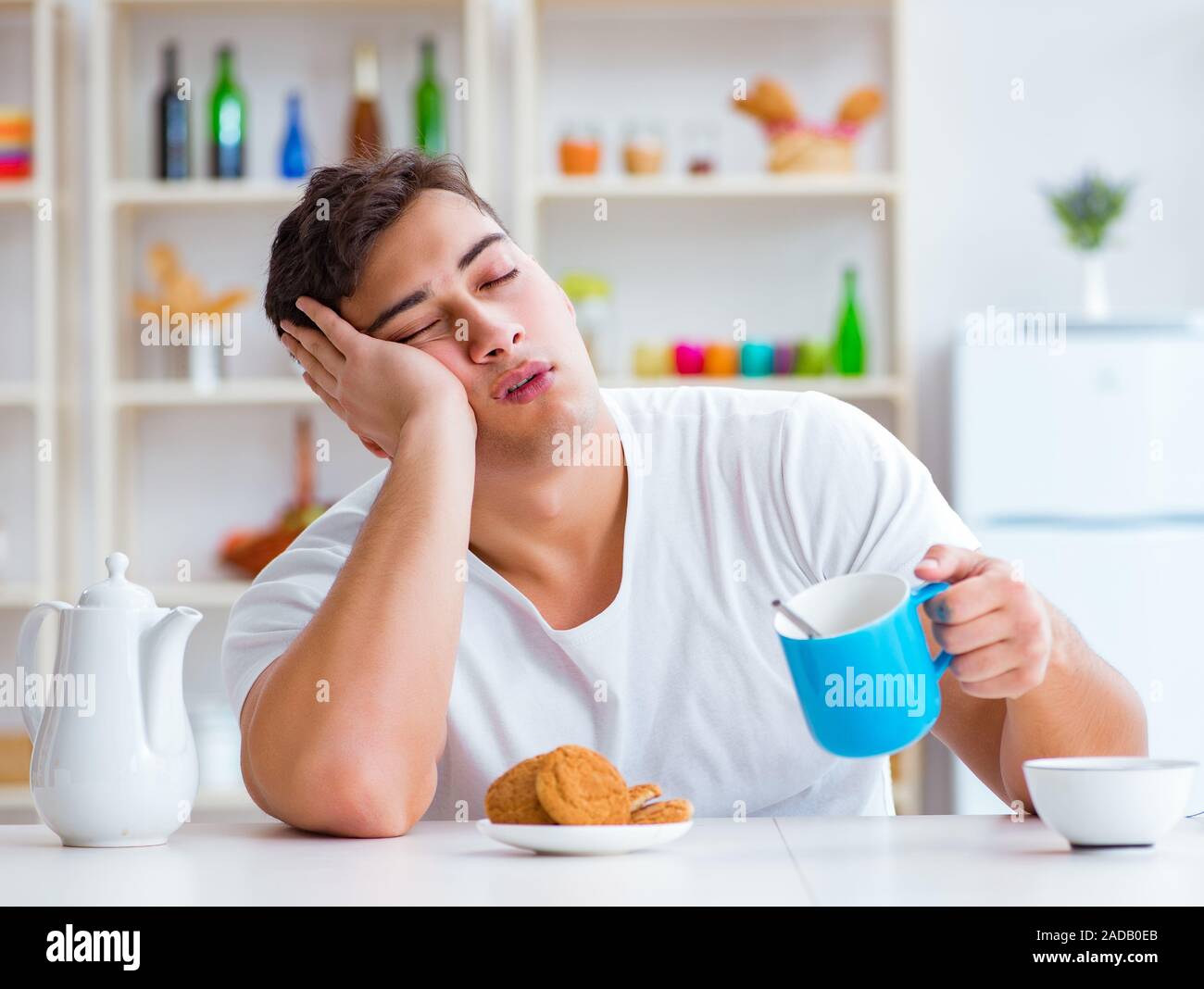 Man falling asleep during his breakfast after overtime work Stock Photo ...