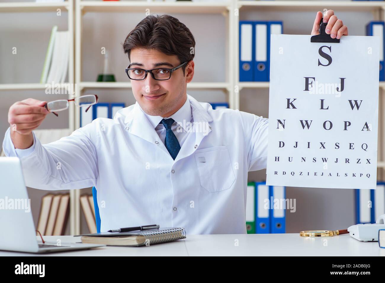 Doctor optician with letter chart conducting an eye test check Stock ...