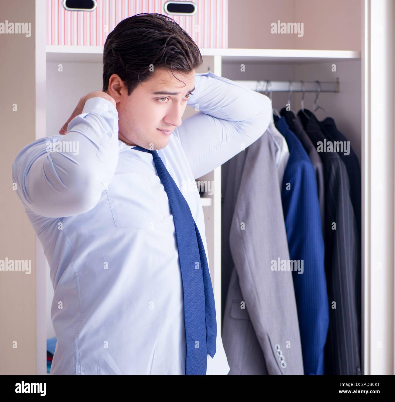Young man Businessman getting dressed for work Stock Photo - Alamy