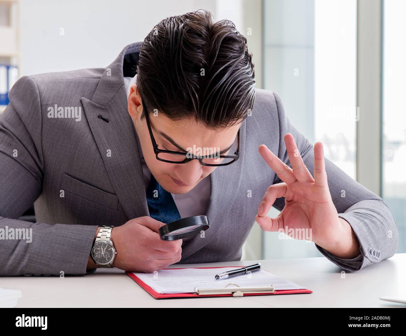 Man looking for errors and mistakes in report Stock Photo - Alamy
