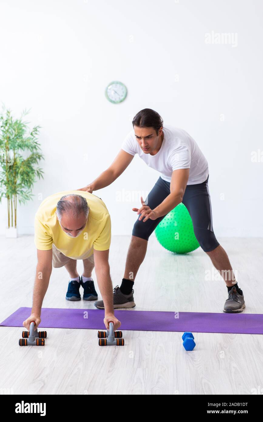 Senior man is doing rehab exercises at home hi-res stock photography ...