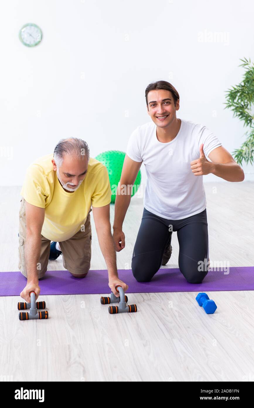 Old man doing exercises indoors Stock Photo - Alamy