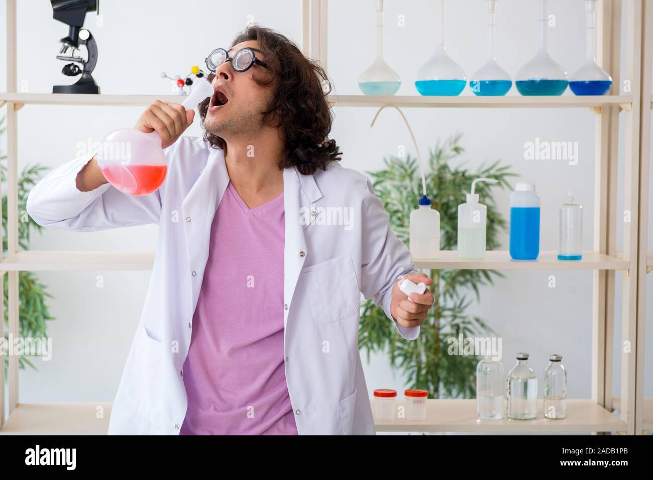 Funny male chemist working in the lab Stock Photo - Alamy