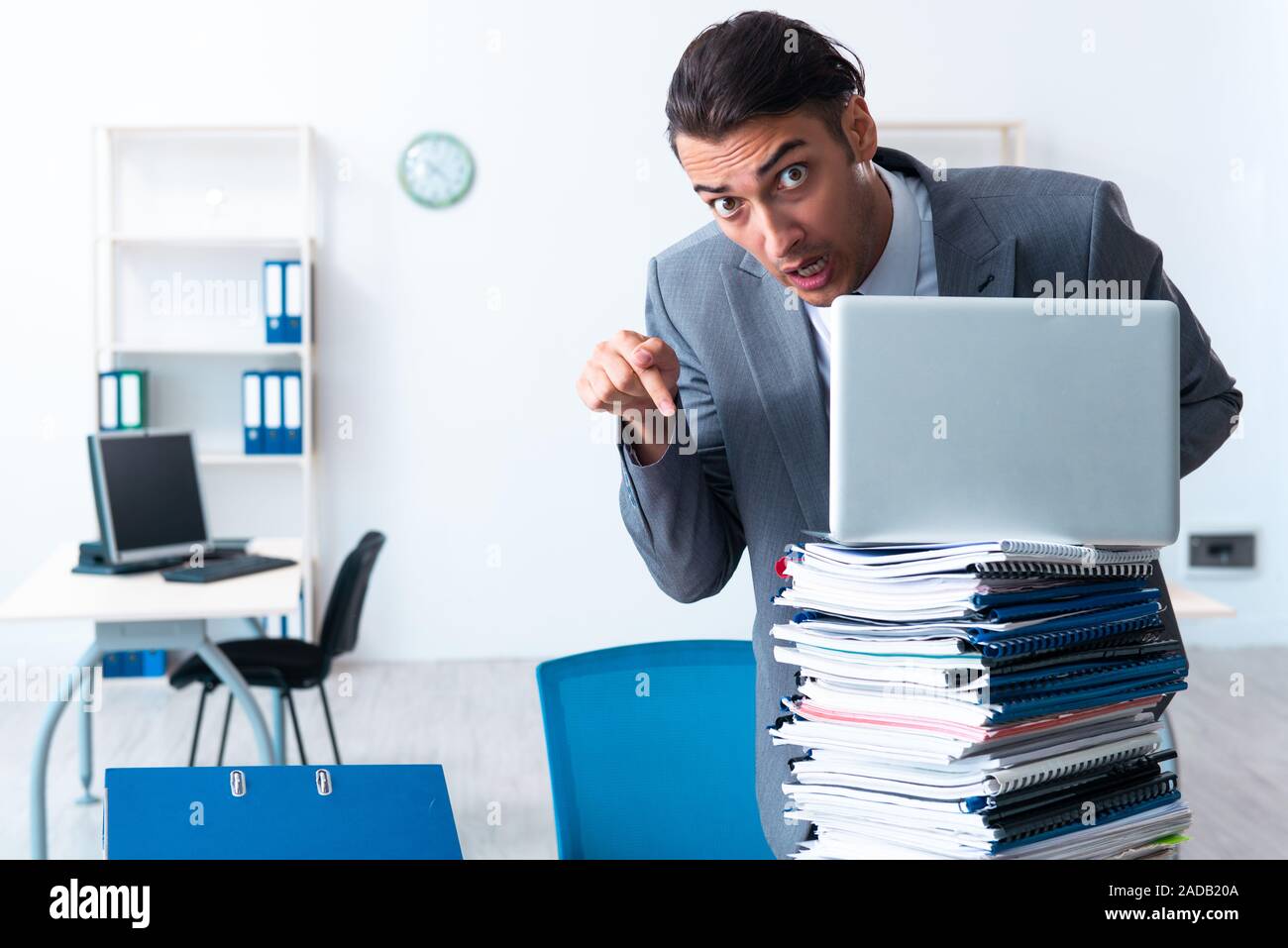 Businessman with heavy paperwork workload Stock Photo - Alamy