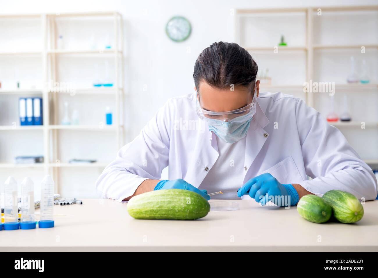 Male nutrition expert testing vegetables in lab Stock Photo - Alamy