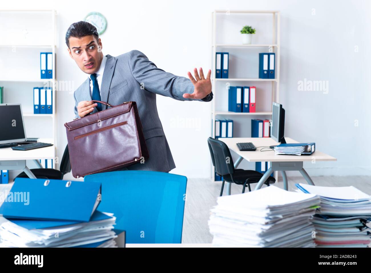 Businessman with heavy paperwork workload Stock Photo - Alamy