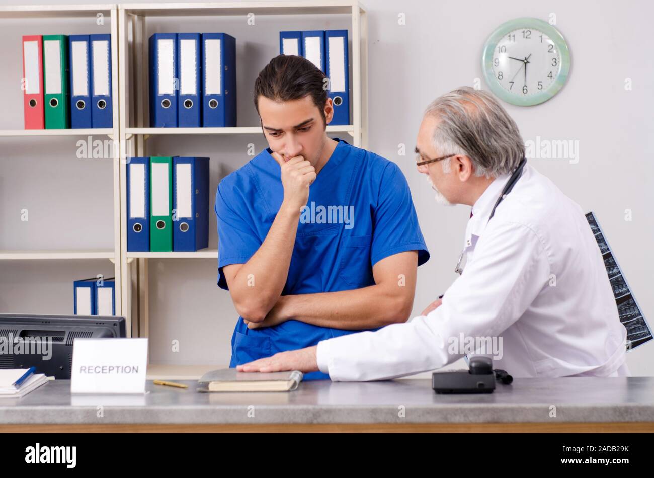 Two doctors talking at the reception in hospital Stock Photo - Alamy