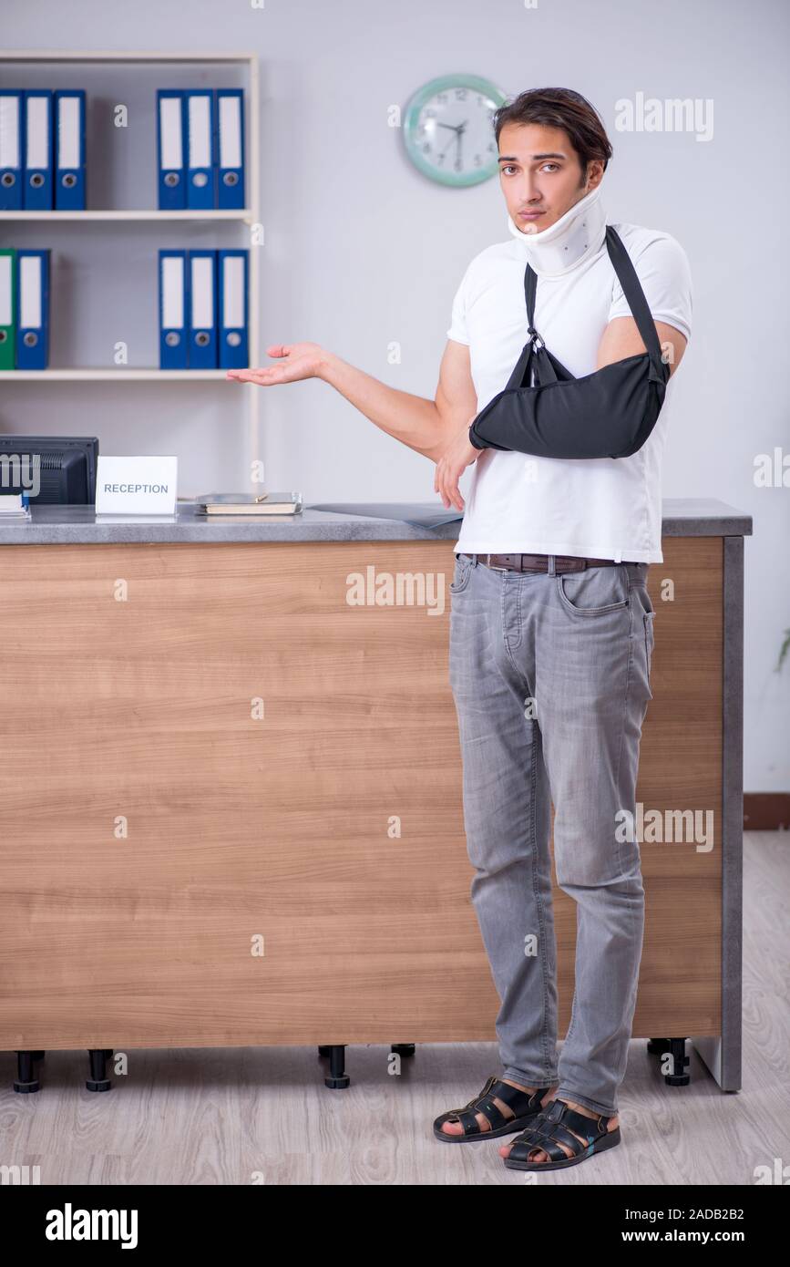 Young man at hospital reception desk Stock Photo - Alamy