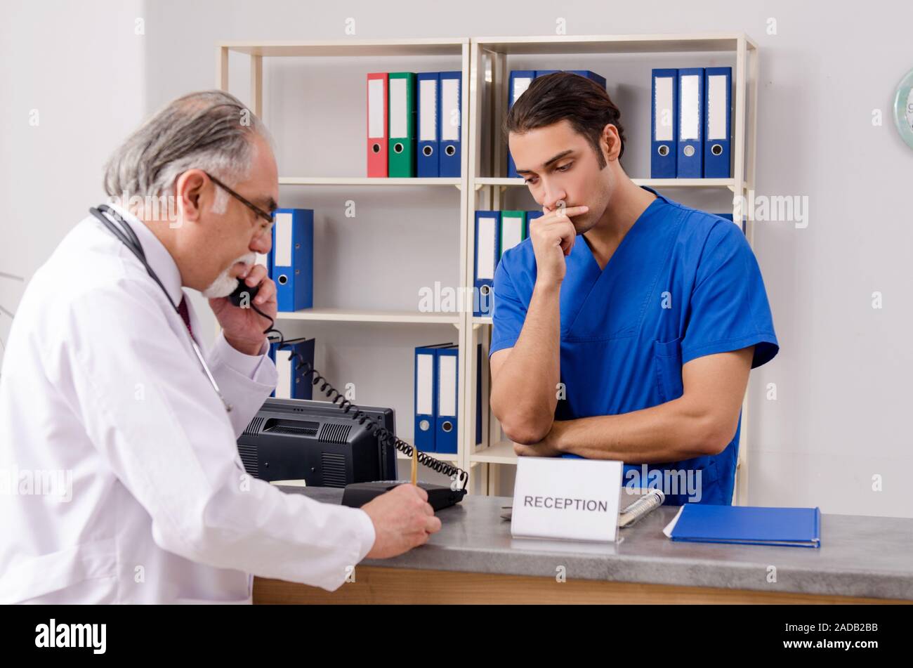 Two doctors talking at the reception in hospital Stock Photo - Alamy