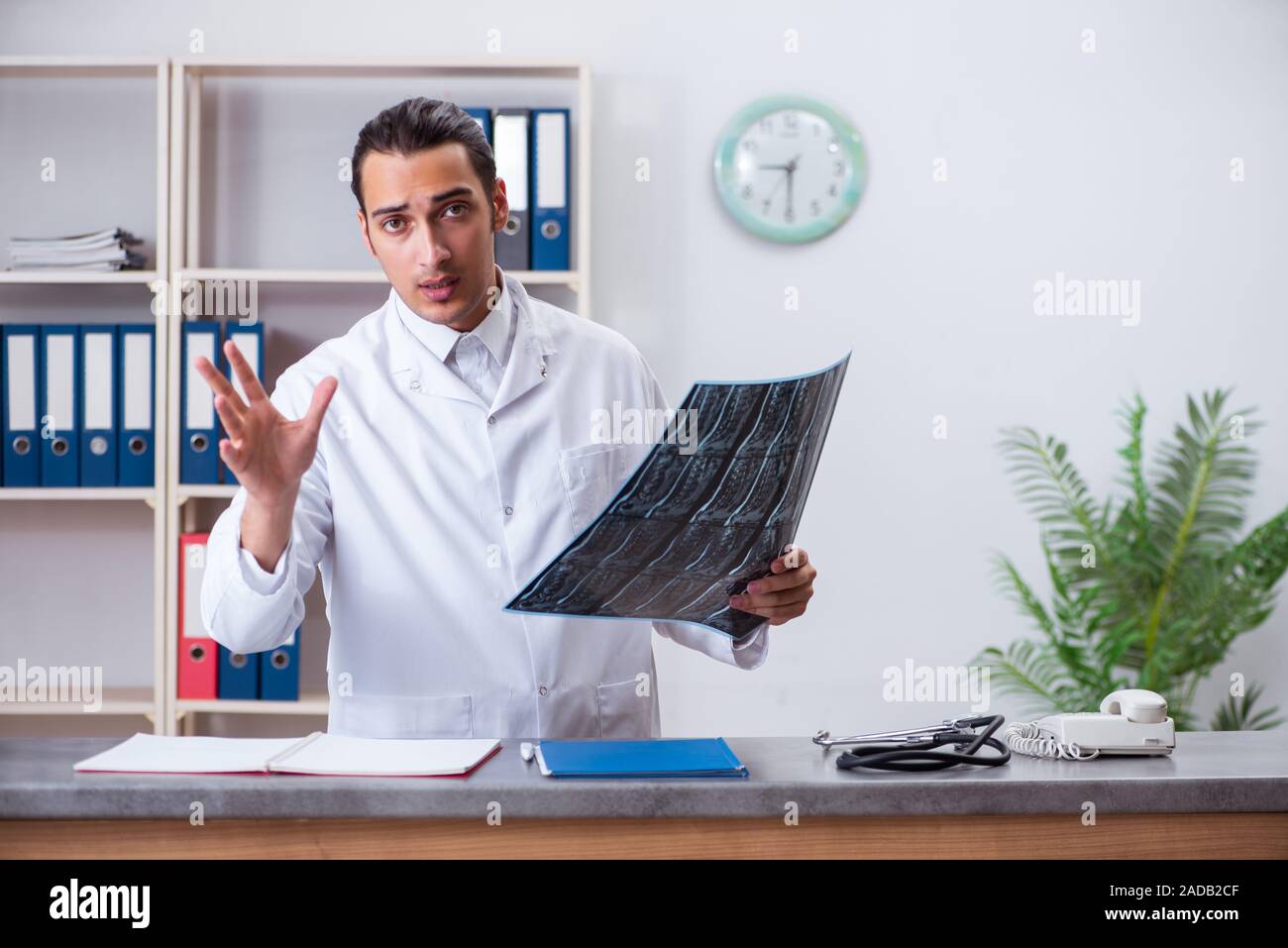 Young male doctor at the reception in the hospital Stock Photo - Alamy