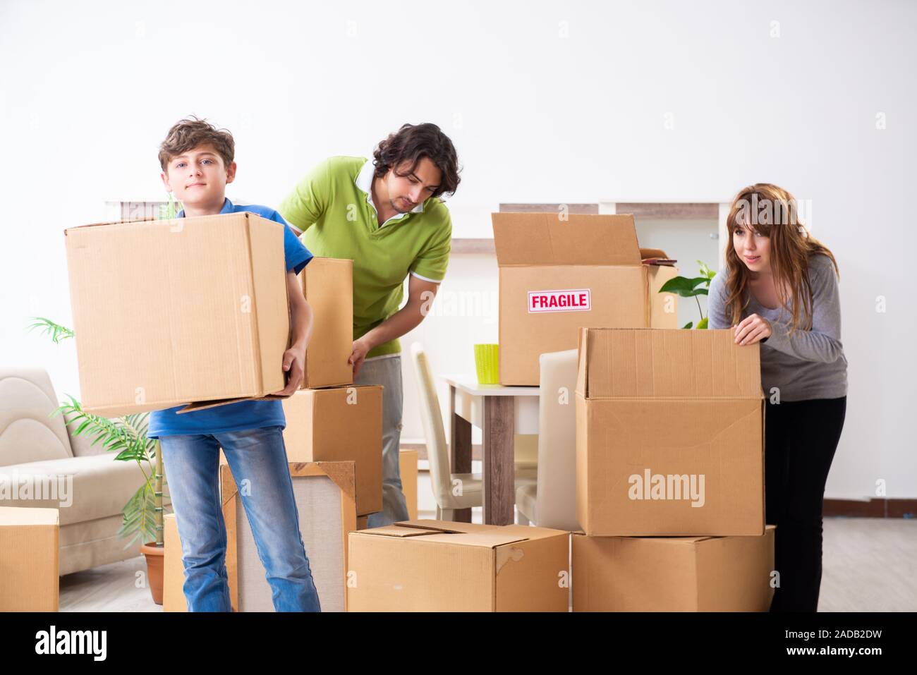 Young family moving to new flat Stock Photo - Alamy