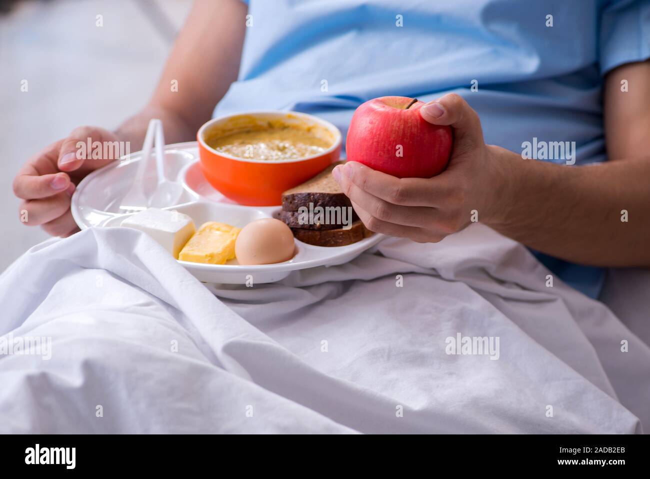Male patient eating food in the hospital Stock Photo - Alamy