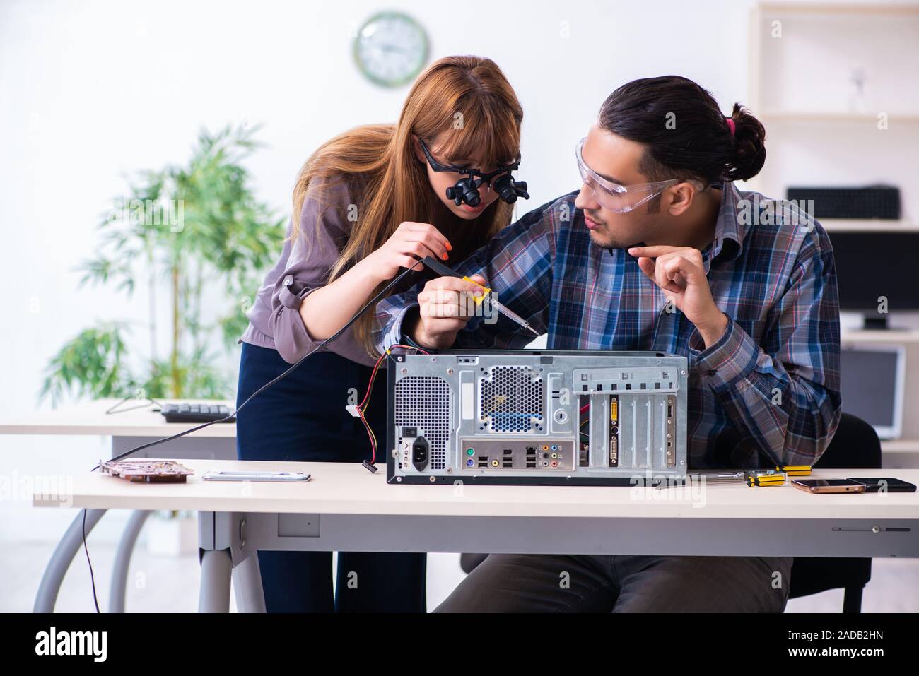 Two repairmen repairing desktop computer Stock Photo - Alamy