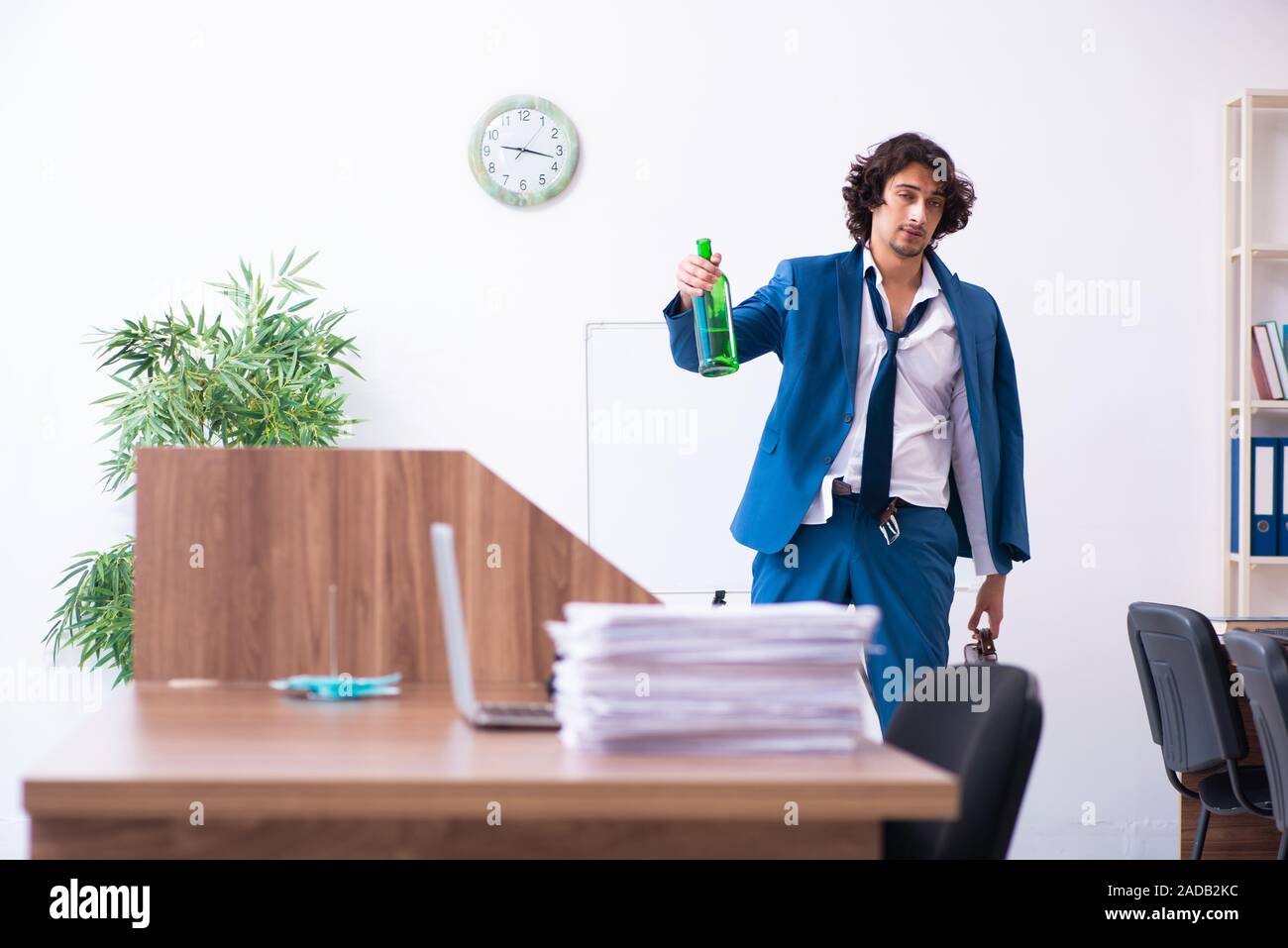 Young drunk employee in the office Stock Photo - Alamy