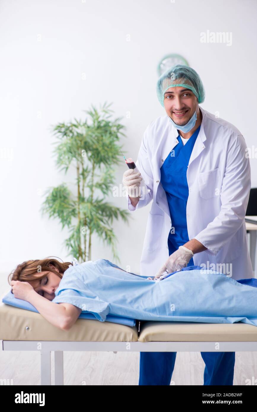 Female patient getting an injection in the clinic Stock Photo - Alamy