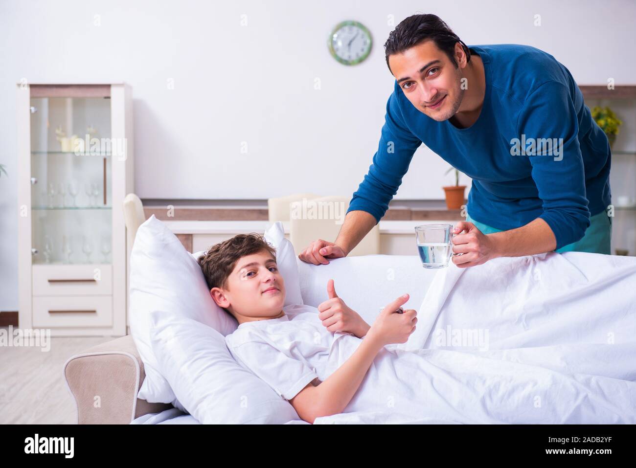 Young father caring for sick son Stock Photo - Alamy