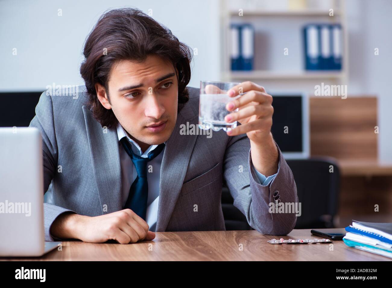 Sick male employee suffering in the office Stock Photo - Alamy