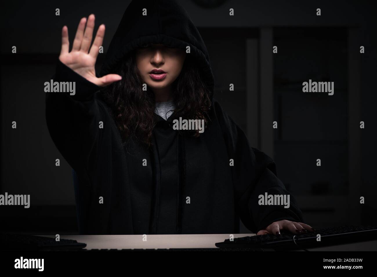 Female hacker hacking security firewall late in office Stock Photo - Alamy