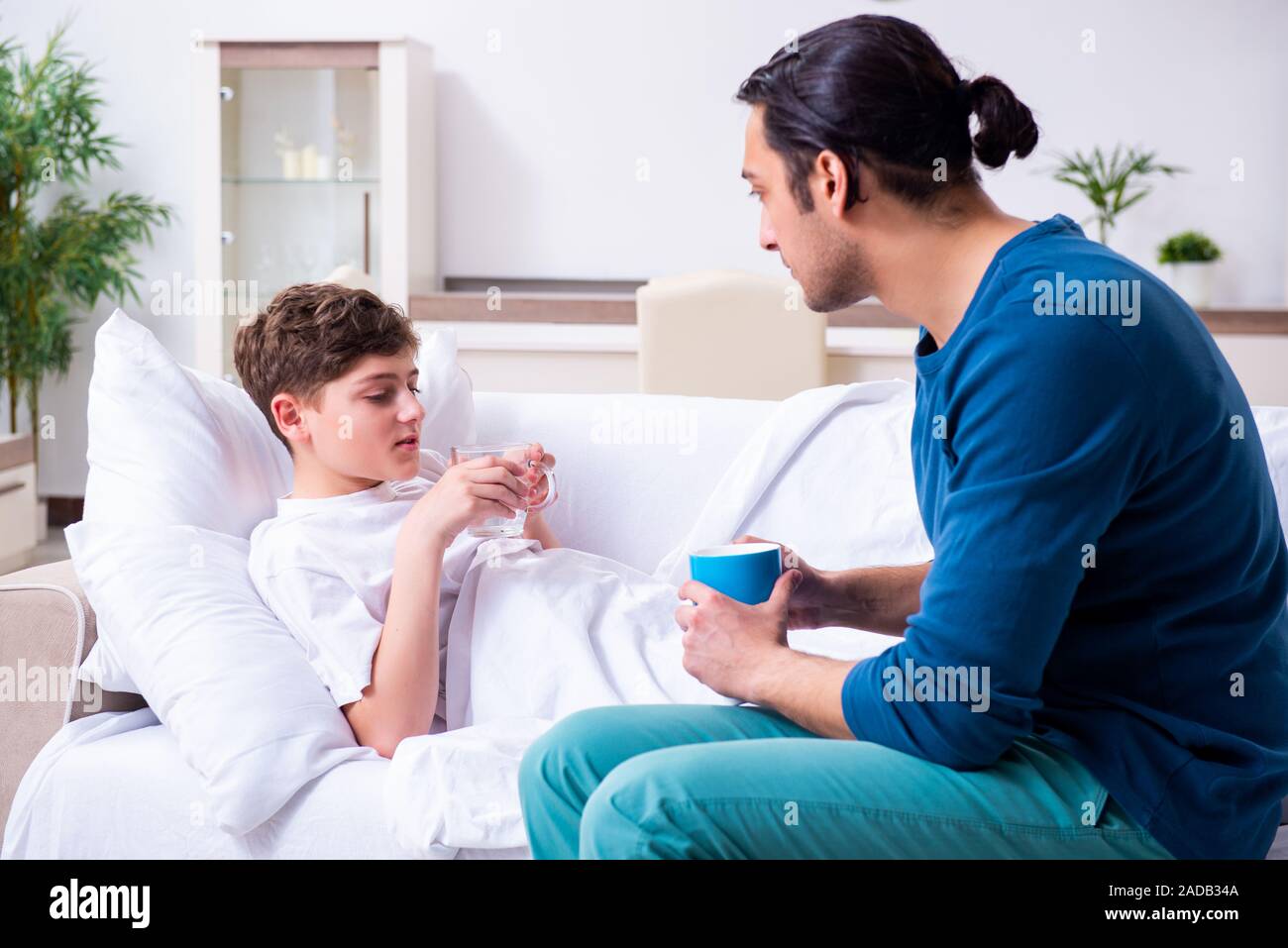 Young father caring for sick son Stock Photo - Alamy