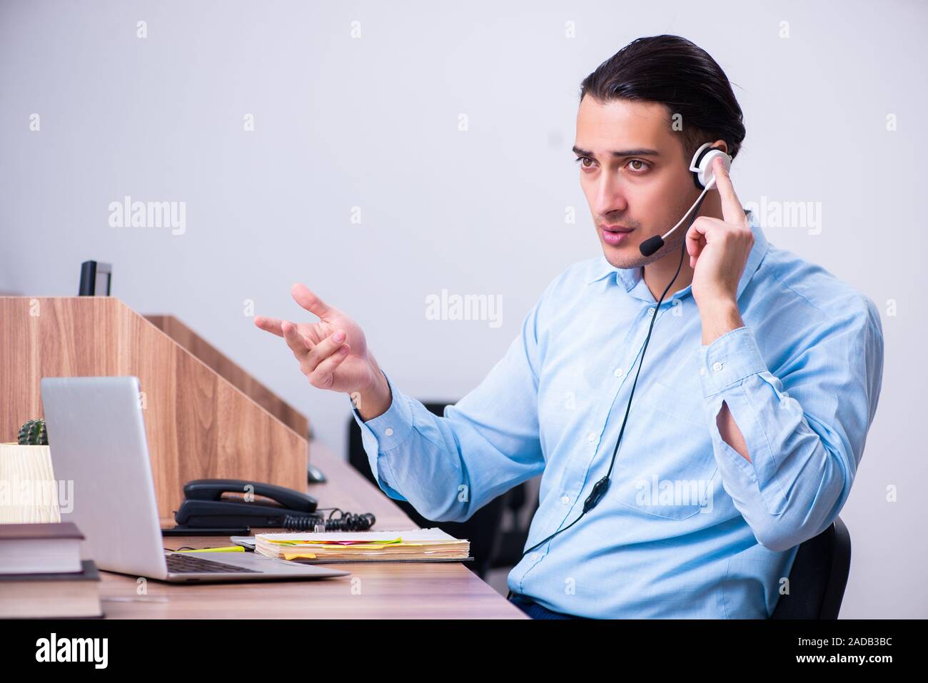Call center operator working at his desk Stock Photo - Alamy