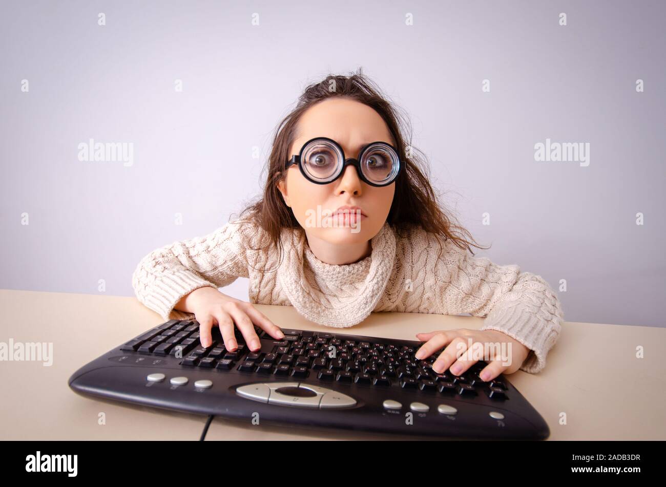 Funny nerd girl working on computer Stock Photo - Alamy