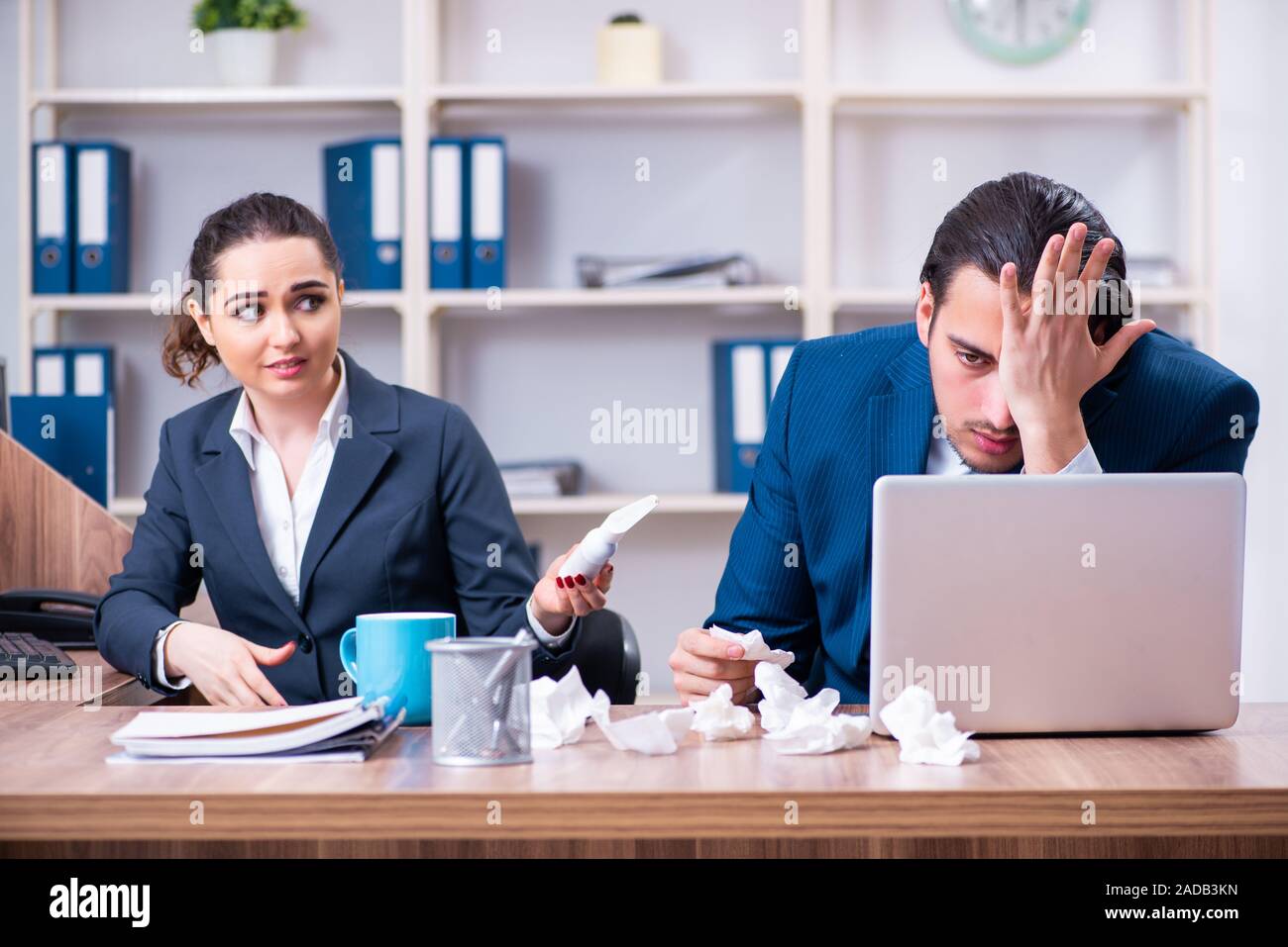 Two employees suffering at workplace Stock Photo - Alamy
