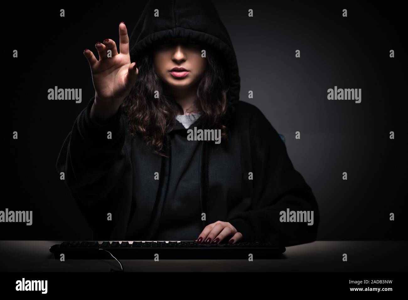 Female hacker hacking security firewall late in office Stock Photo - Alamy