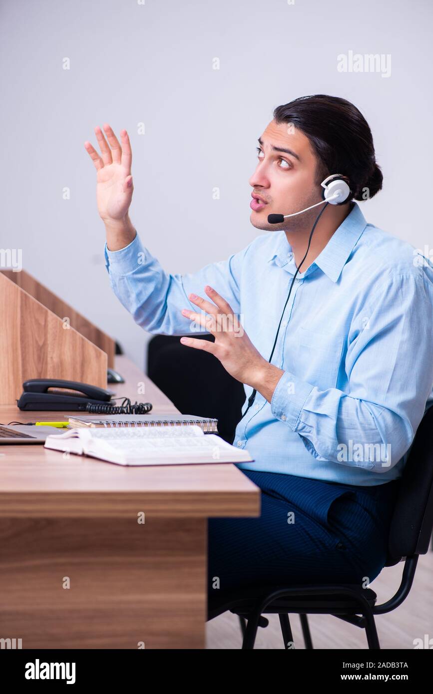 Call center operator working at his desk Stock Photo - Alamy