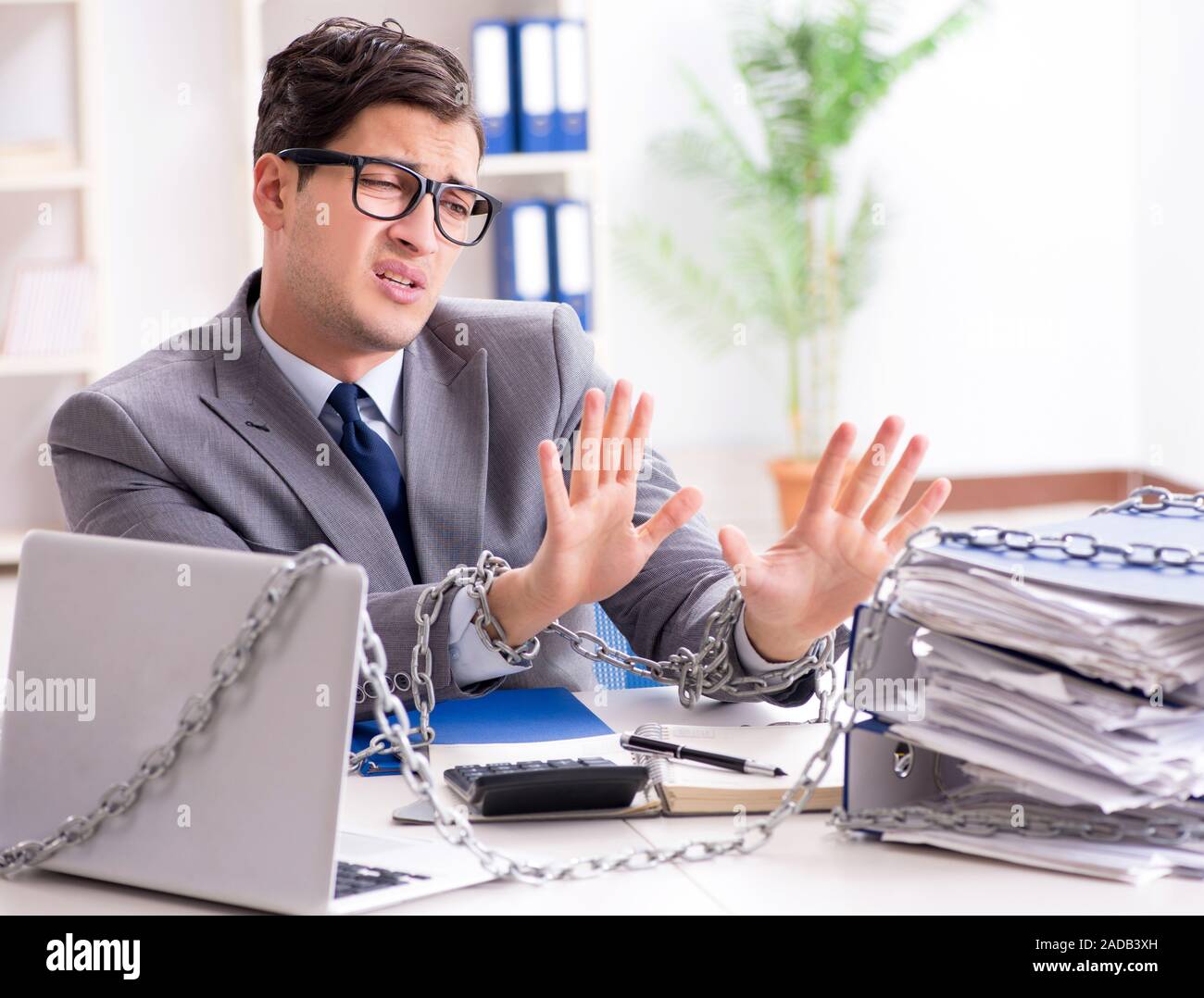 Man chained to desk hi-res stock photography and images - Alamy