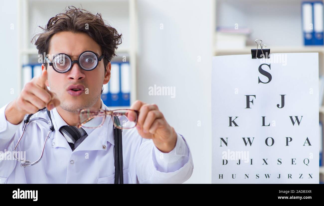 Funny eye doctor in humourous medical concept Stock Photo - Alamy