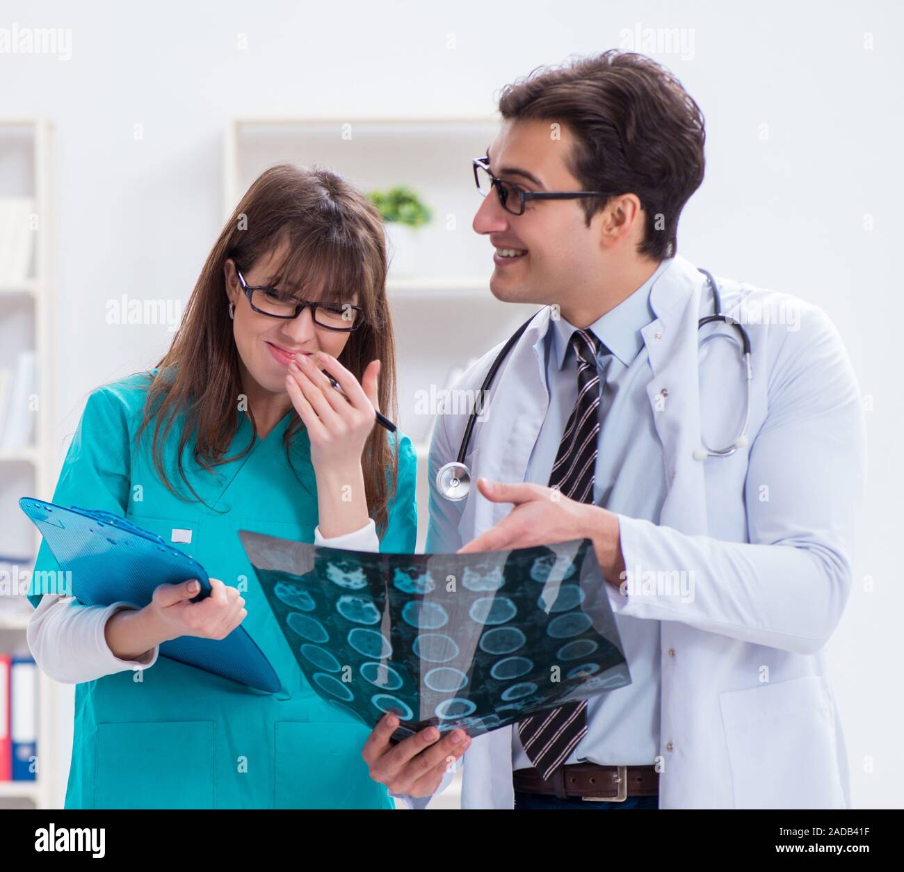 Three doctors discussing scan results of x-ray image Stock Photo - Alamy