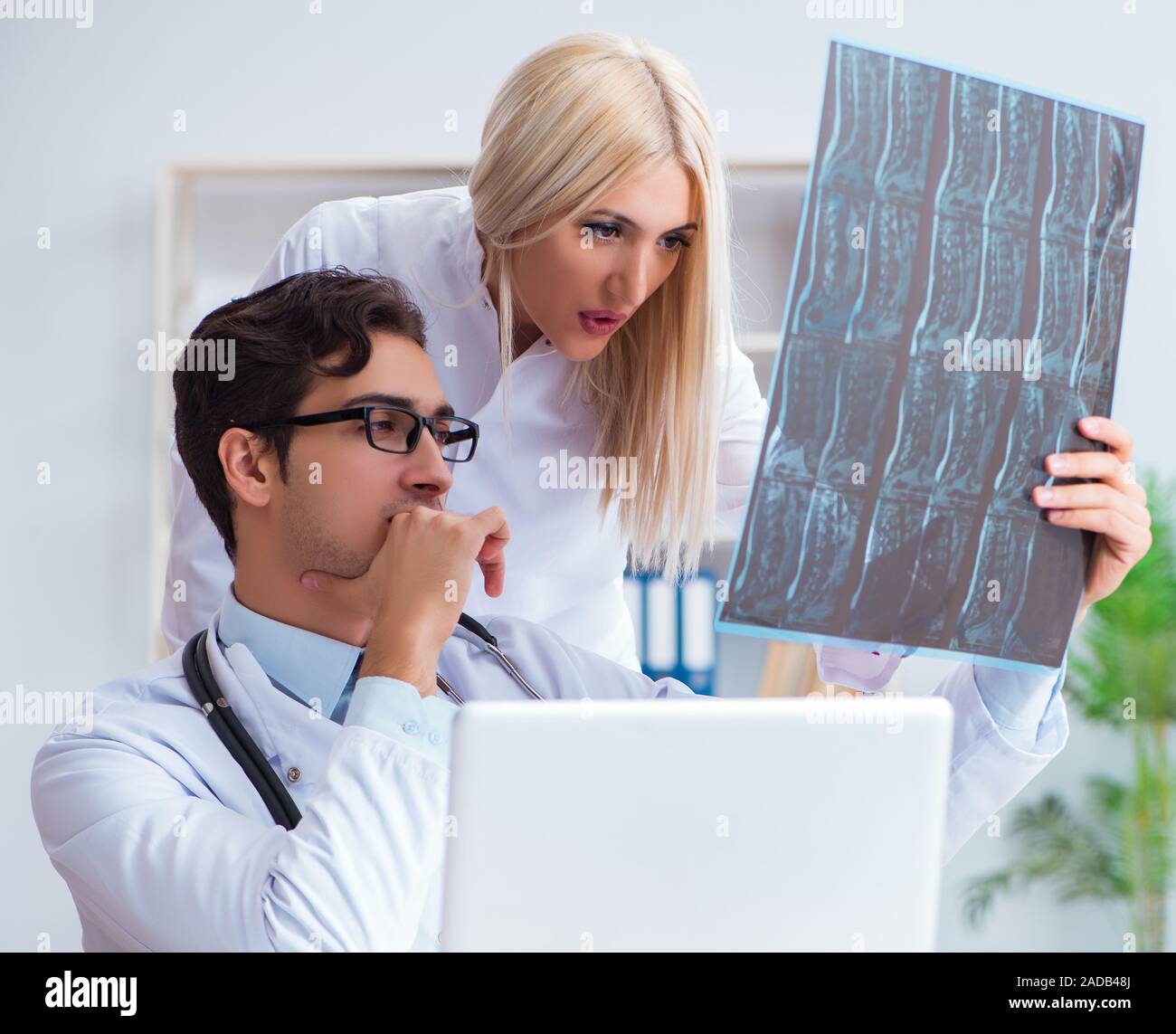 The two doctors examining x-ray images of patient for diagnosis Stock ...