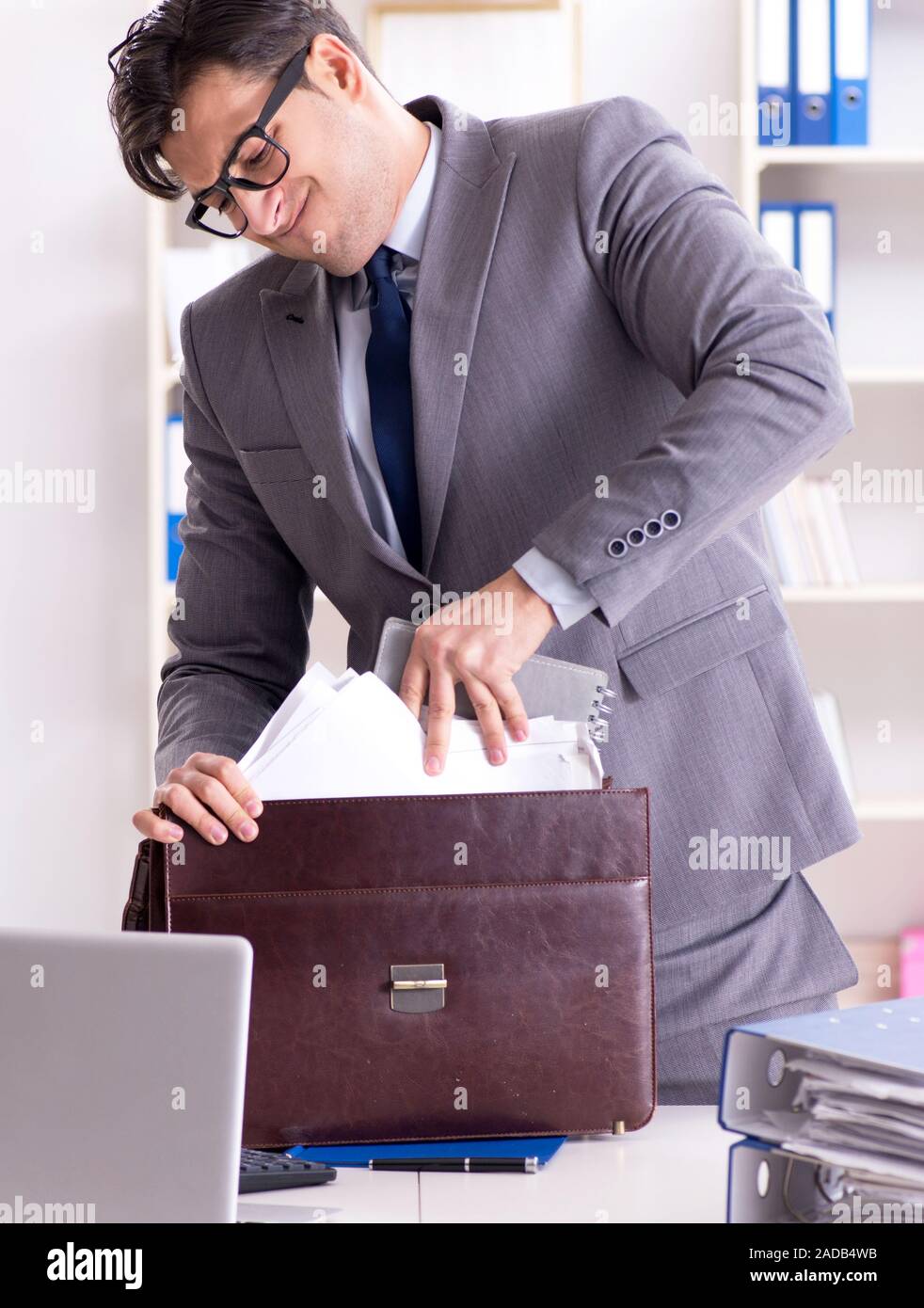 Employee with too much work taking it home Stock Photo - Alamy