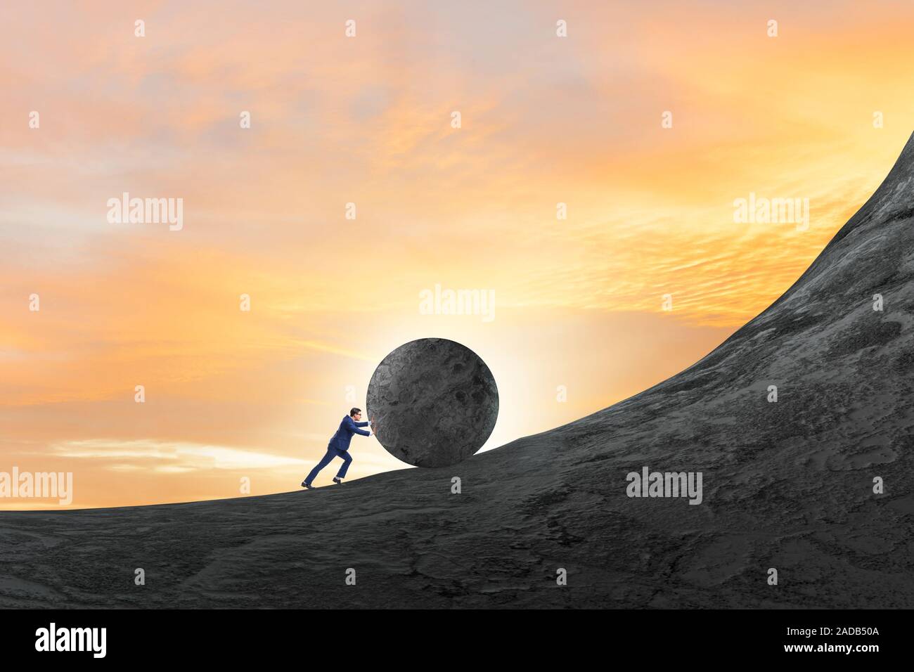 Man pushing large stone to the top Stock Photo - Alamy