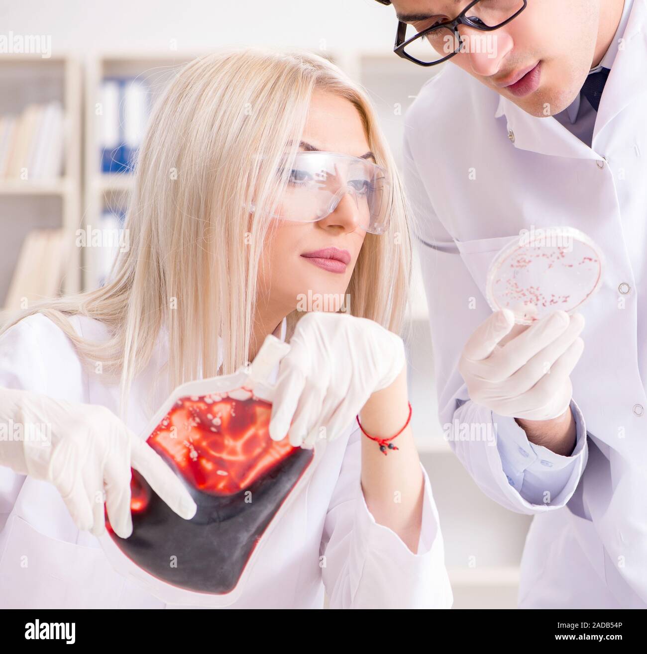 Woman female doctor looking at blood samples in ba hi-res stock ...