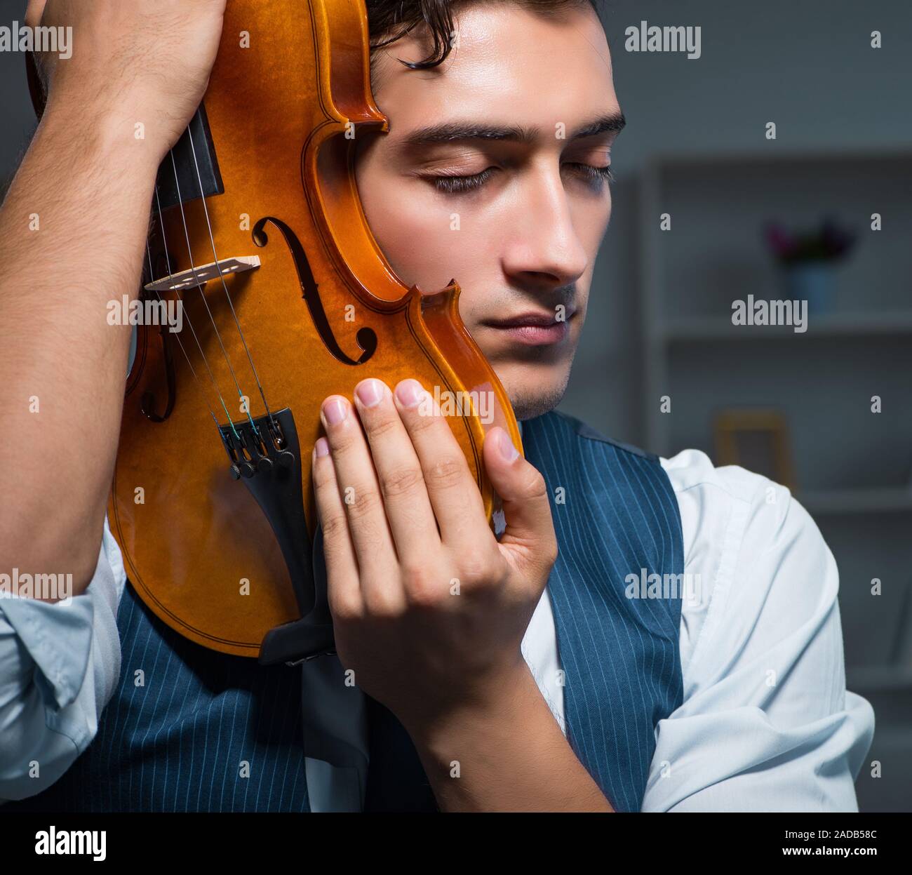 Young musician man practicing playing violin at home Stock Photo - Alamy