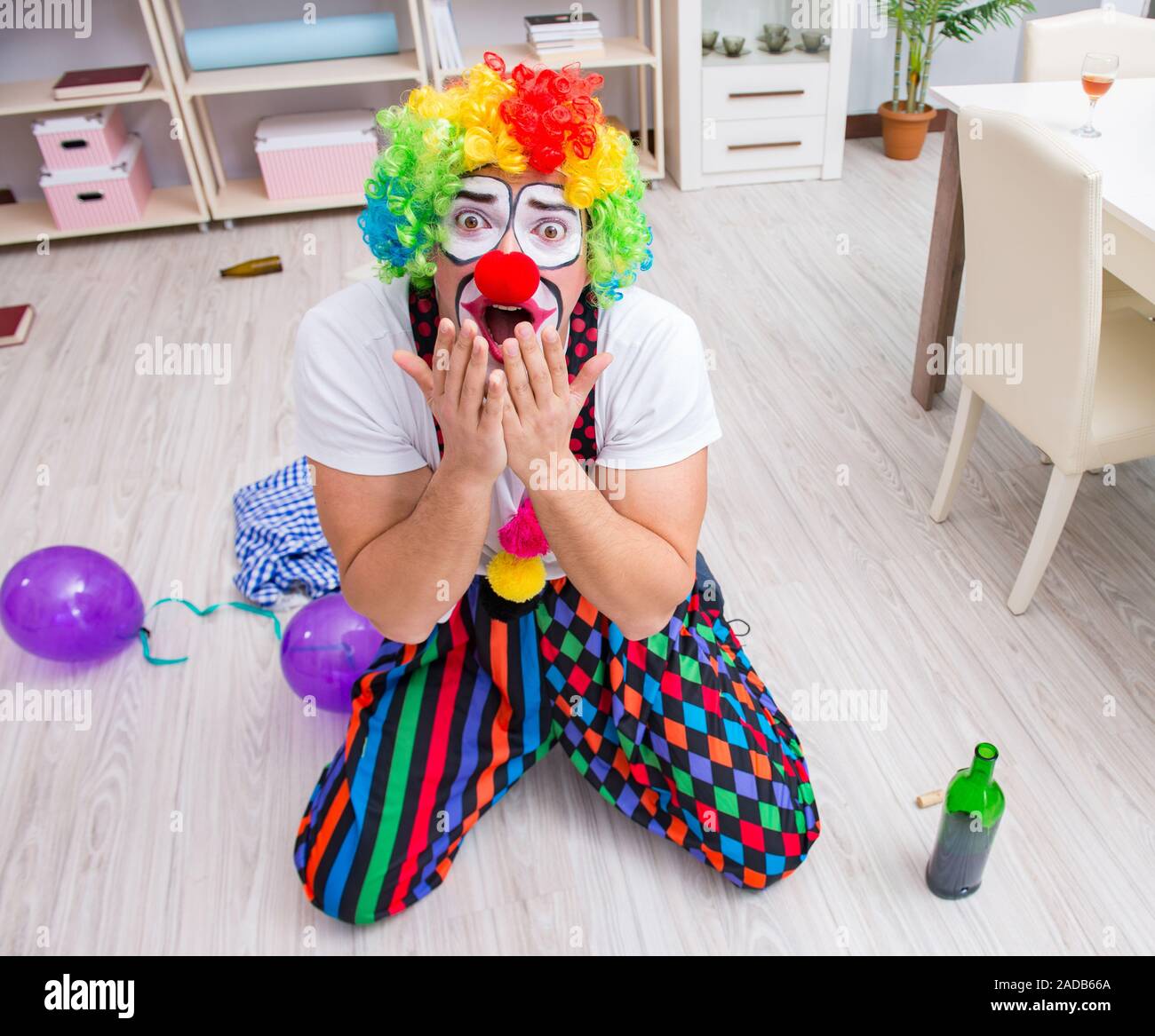 Drunk clown celebrating having a party at home Stock Photo - Alamy