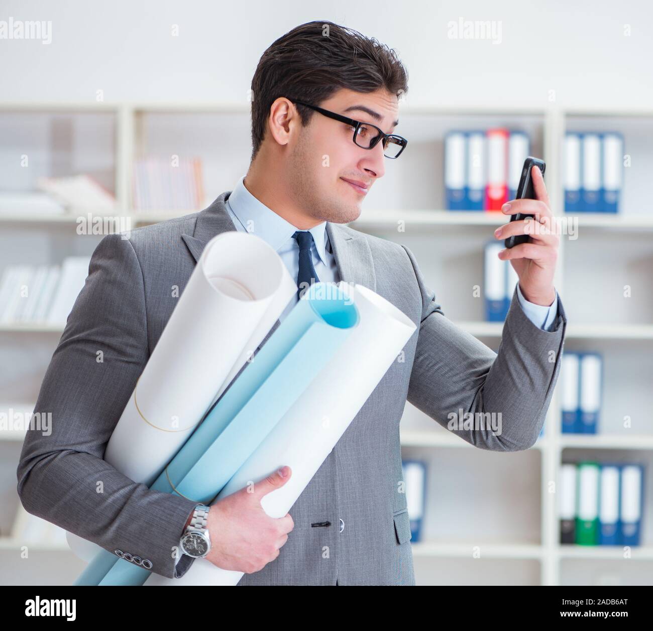 Businessman engineer draftsman with blueprints drawings Stock Photo - Alamy