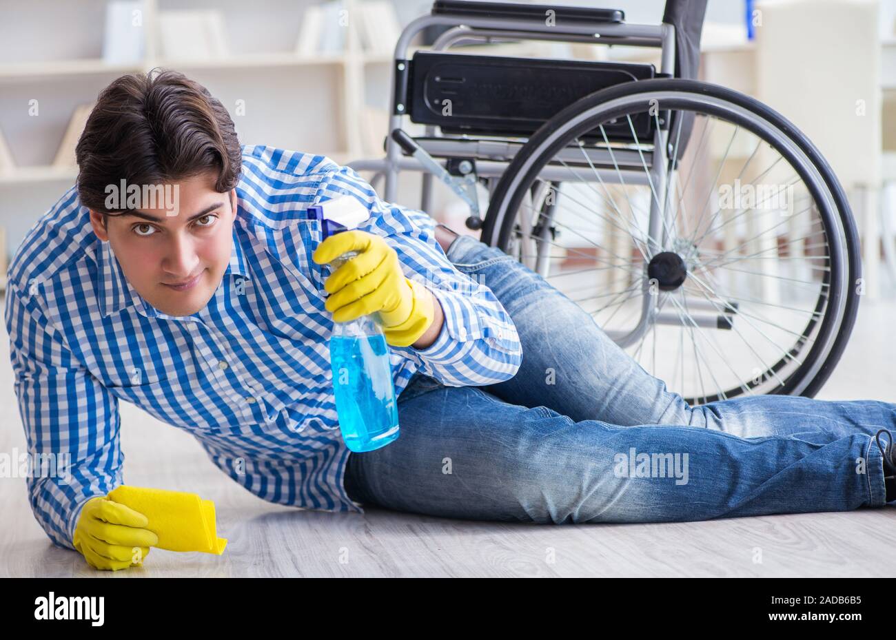 Disabled man on wheelchair cleaning home Stock Photo - Alamy