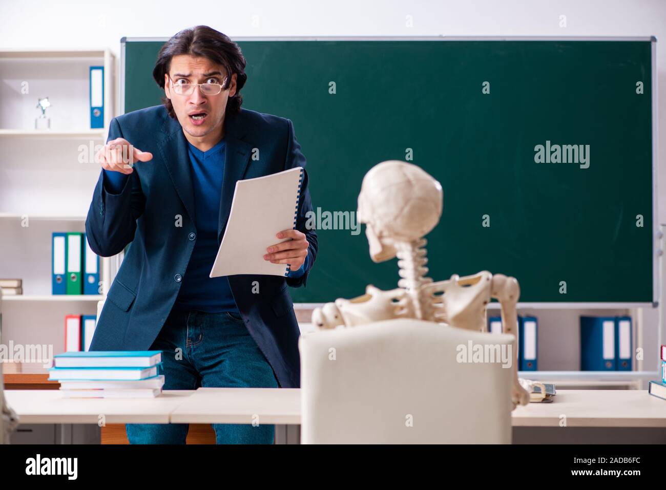 Male teacher and skeleton student in the classroom Stock Photo - Alamy