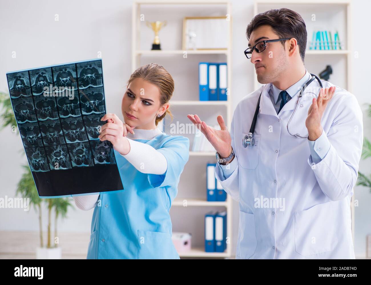 The two doctors examining x-ray images of patient for diagnosis Stock ...