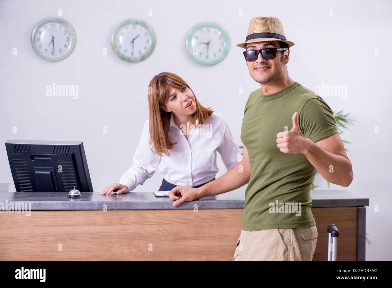 Young man at the hotel reception Stock Photo - Alamy