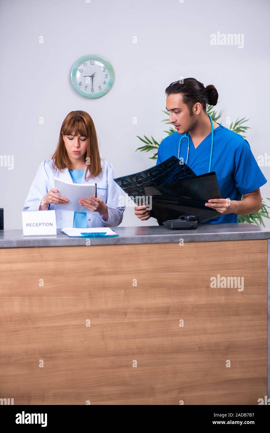 Two doctors working at the reception in the hospital Stock Photo - Alamy