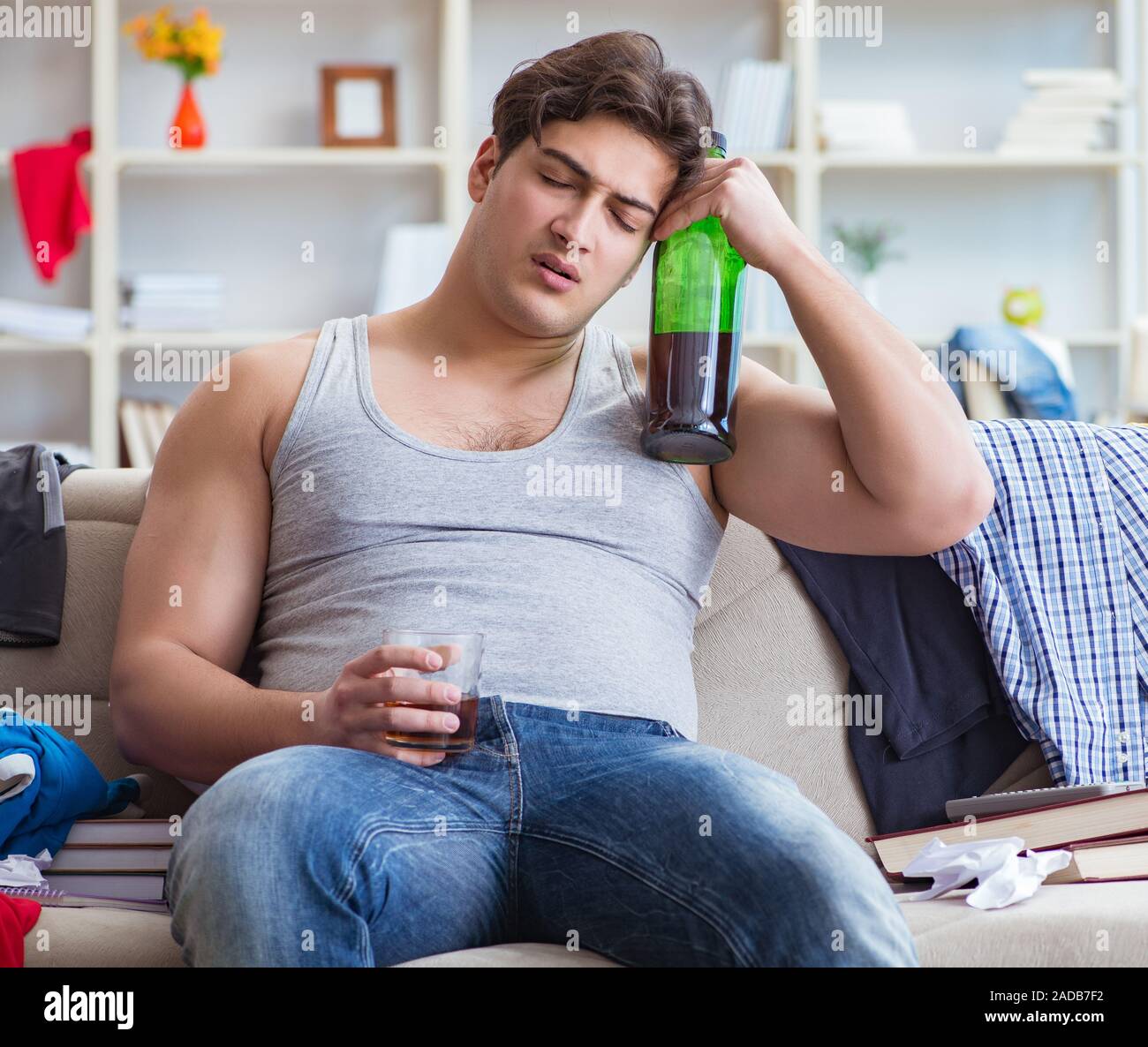 Young man student drunk drinking alcohol in a messy room Stock Photo ...