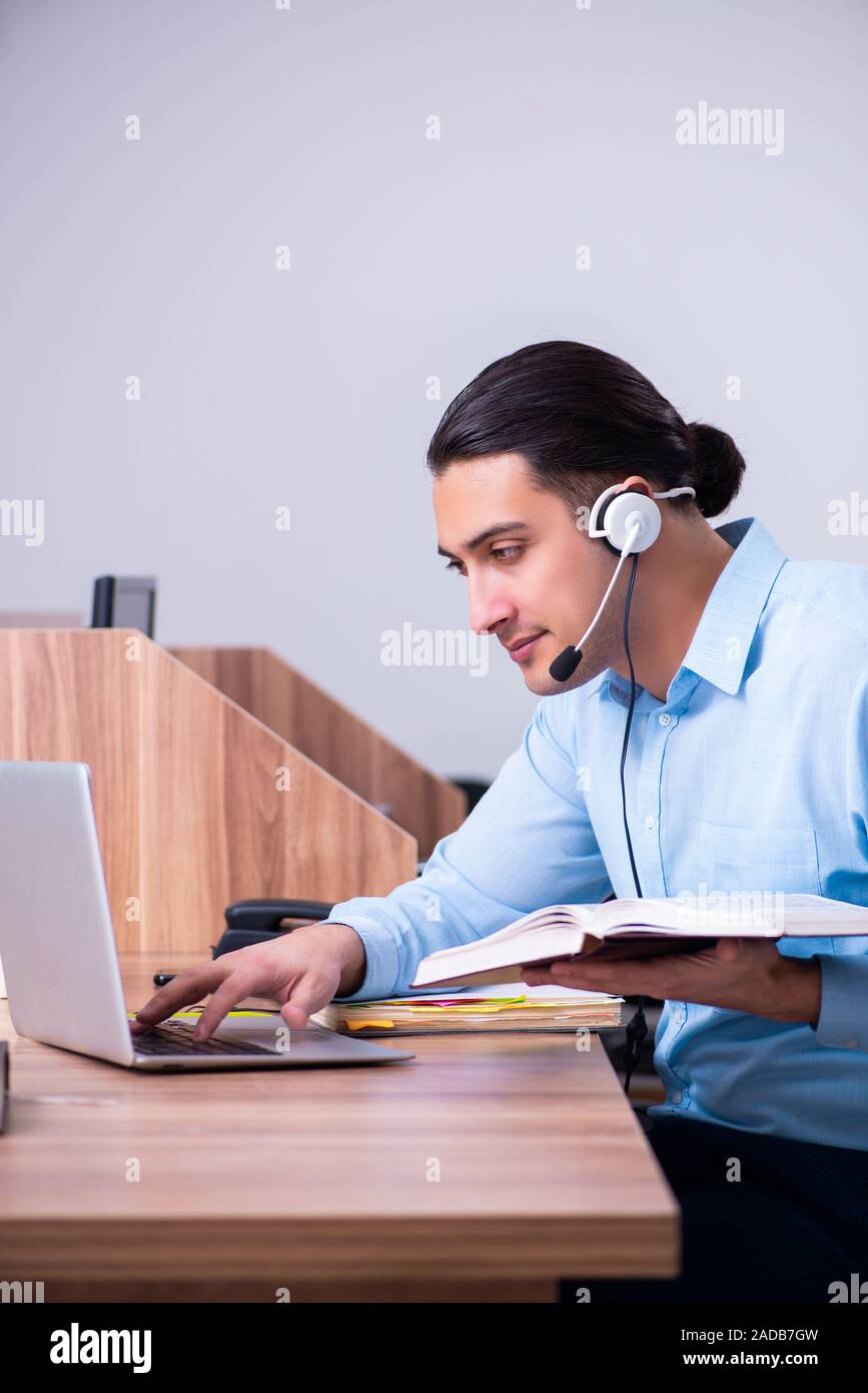 Call center operator working at his desk Stock Photo - Alamy